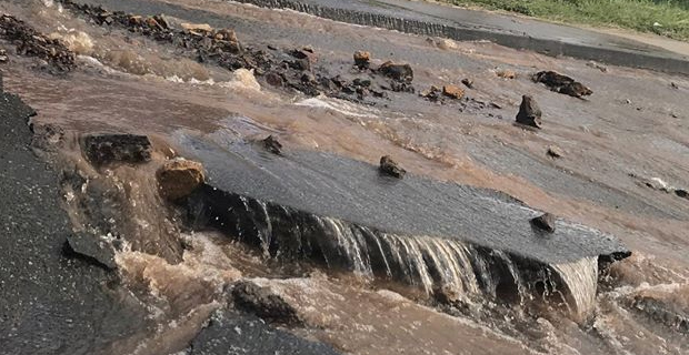 Burst main in front of Laqere washes away part of tarsealed road